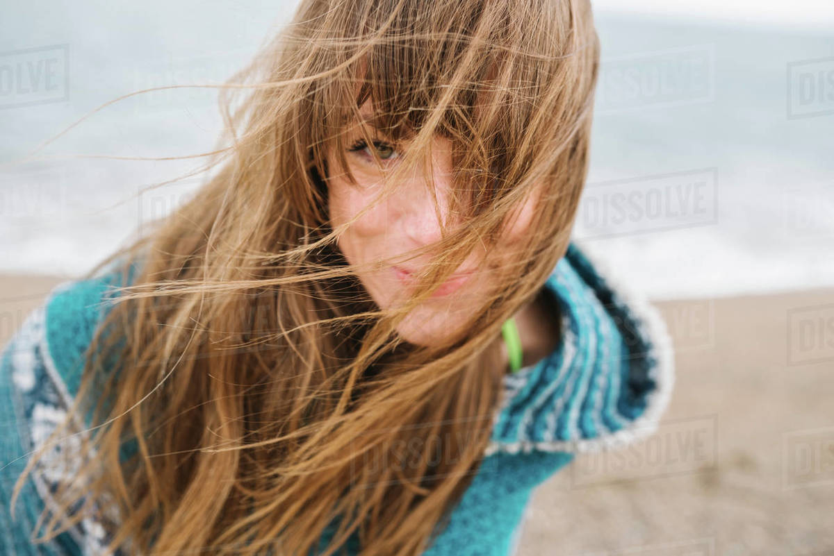 Woman with windswept hair on beach, portrait, Barcelona, Spain - Stock ...
