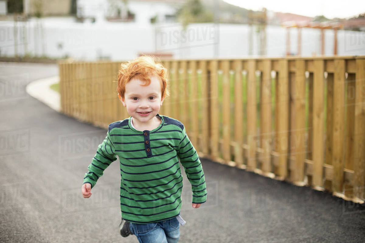 Boy running on road in residential area - Royalty-free Stock Photo ...