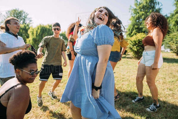 Group of friends dancing in park - Stock Photo - Dissolve