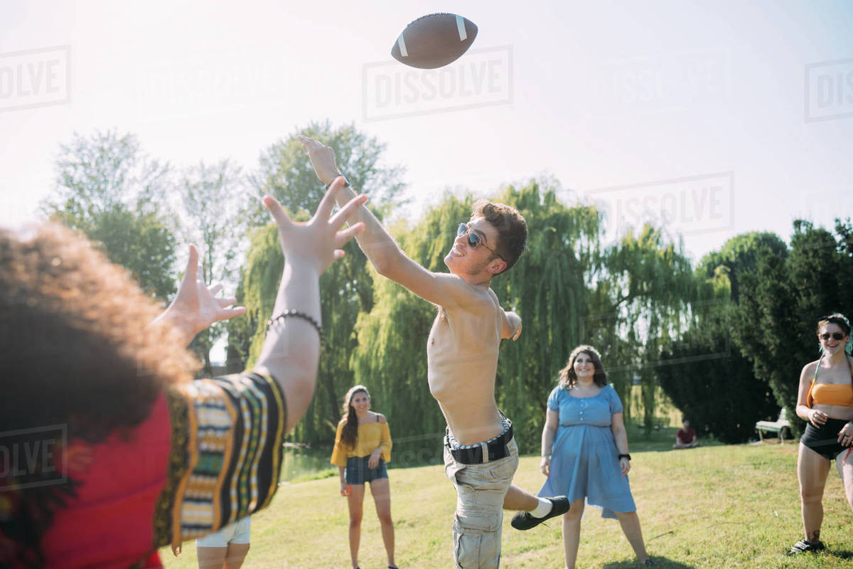 Group of friends playing football in park - Royalty-free Stock Photo ...