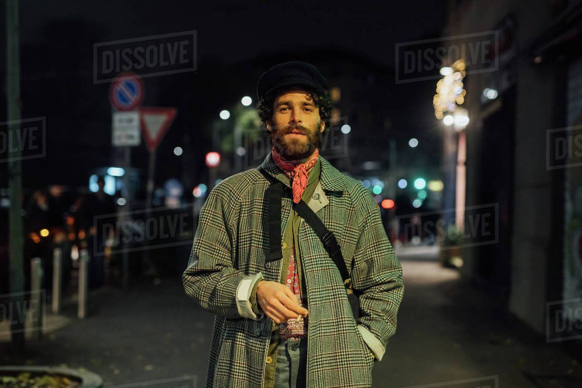 Bearded young man loitering on street - Royalty-free Stock Photo | Dissolve