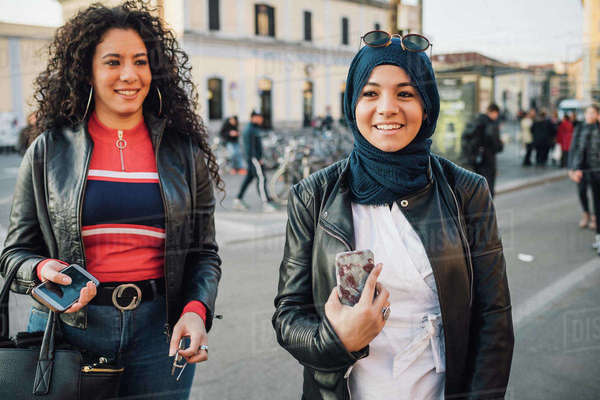 Young woman in hijab with best friend on city street - Royalty-free ...