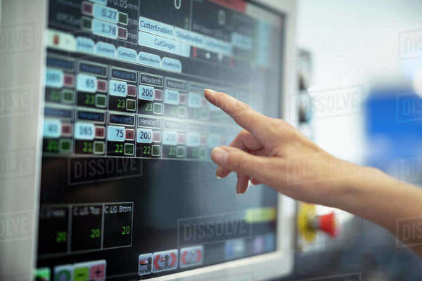 Close up of workers hand on control panel in print factory - Stock ...