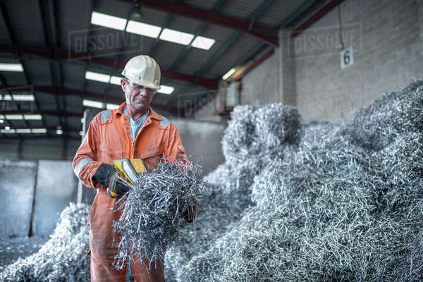 Worker testing titanium swarf in titanium recycling plant - Stock Photo ...