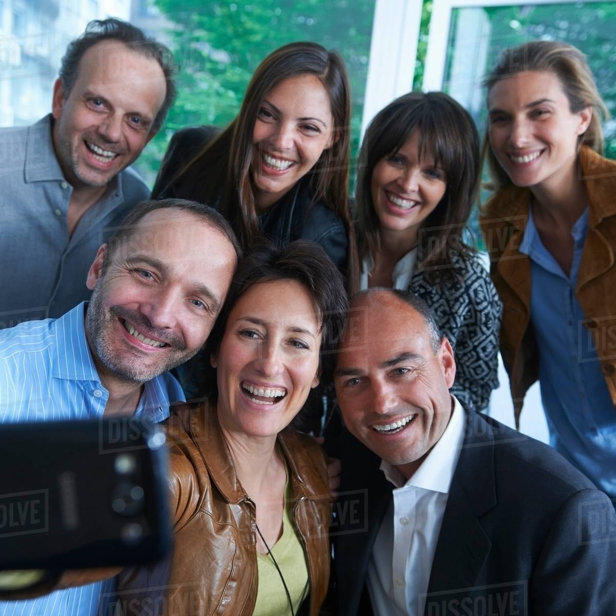Group of people taking self portrait photograph - Stock Photo - Dissolve