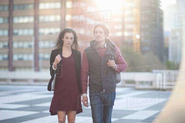 Couple walking across rooftop parking lot in city - Royalty-free Stock ...