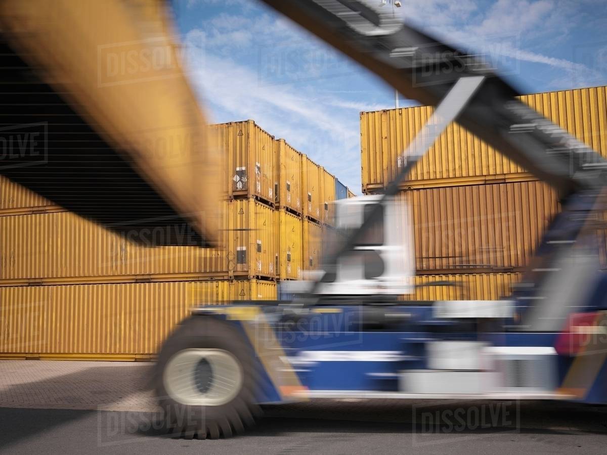 Shipping container stacker in port - Stock Photo - Dissolve
