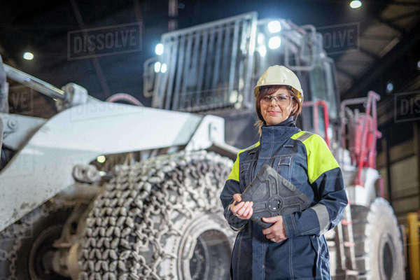 Portrait of female steelworker and dumper truck in steelworks - Royalty ...