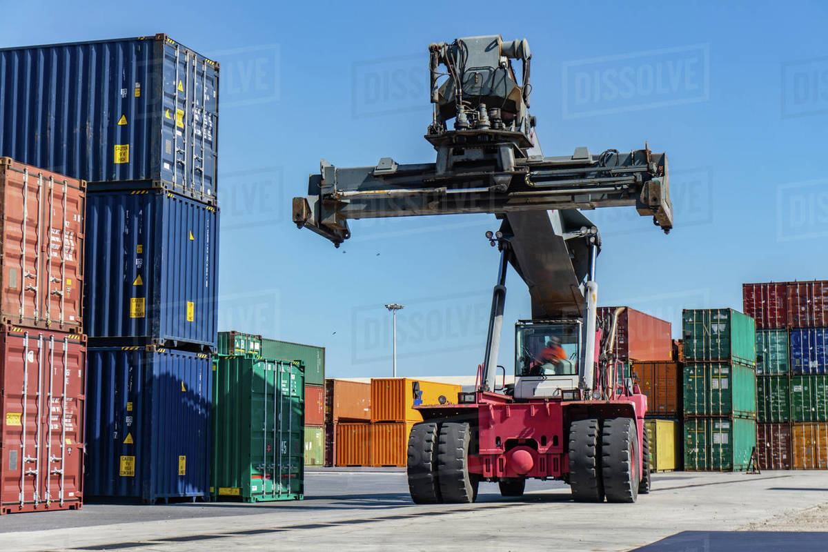 Reach stacker and shipping containers in dock - Royalty-free Stock ...
