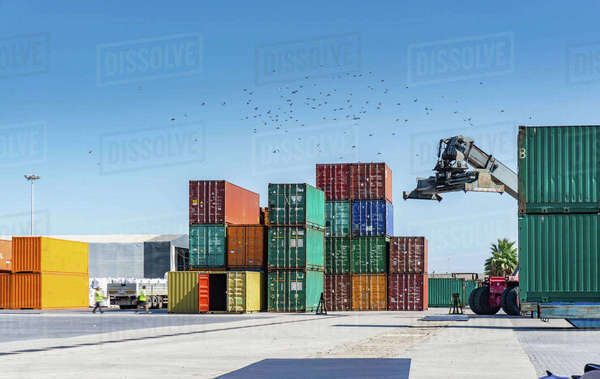 Reach stacker and shipping containers in dock - Royalty-free Stock ...