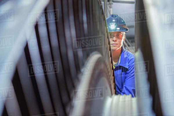 Female engineer inspecting a turbine in a nuclear power station ...