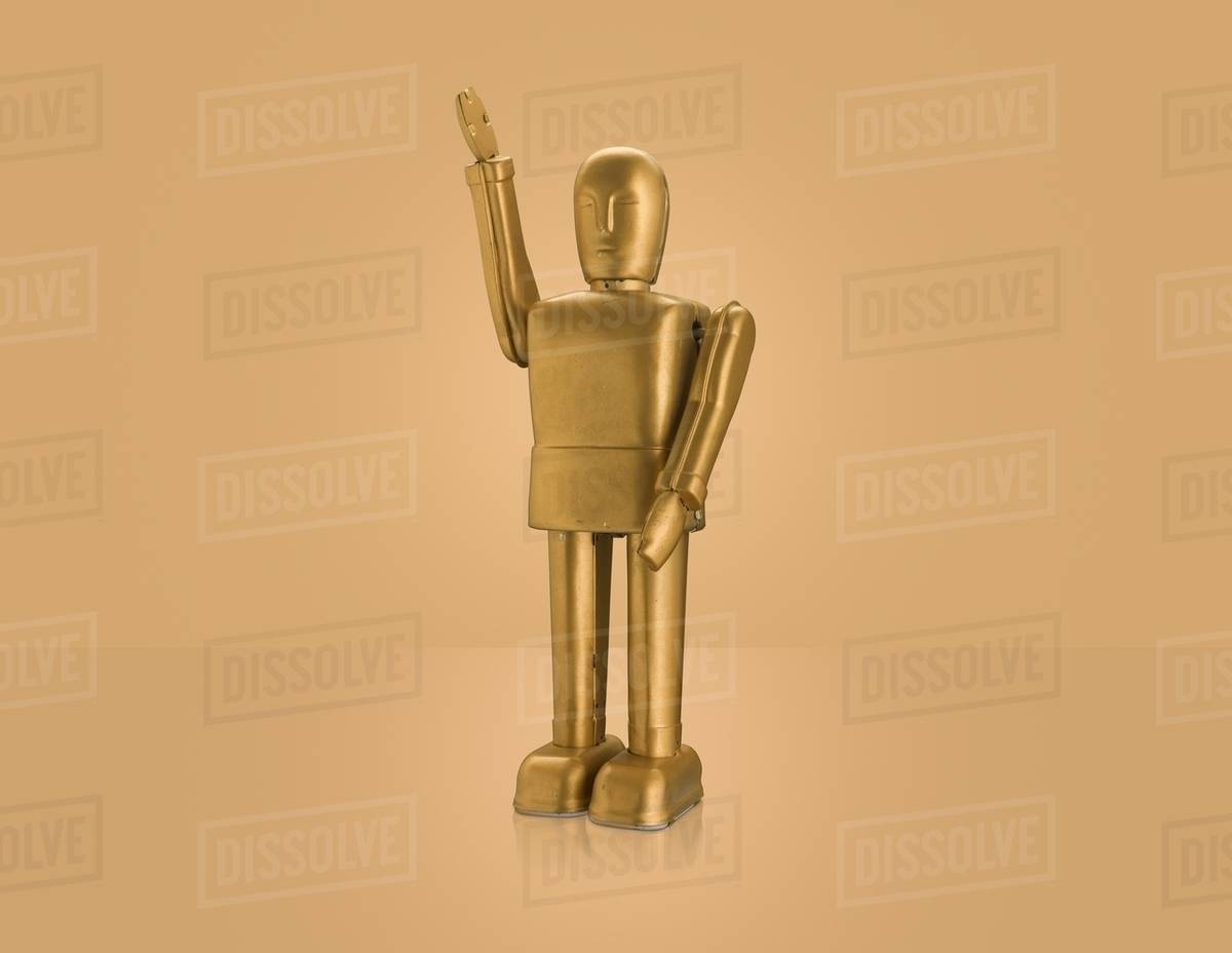 Studio shot of gold robot with arm raised - Royalty-free Stock Photo ...