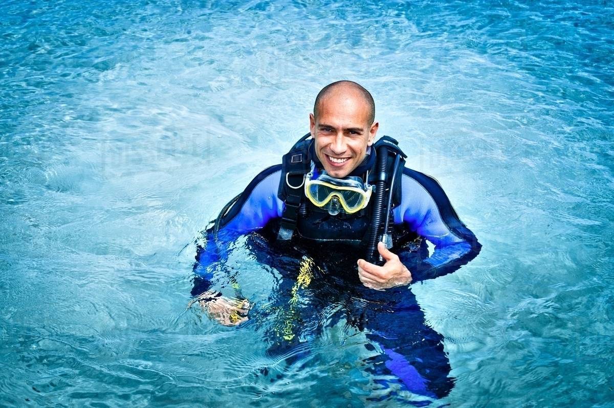 Portrait of mid adult man scuba diving in sea, La Maddalena, Sardinia ...