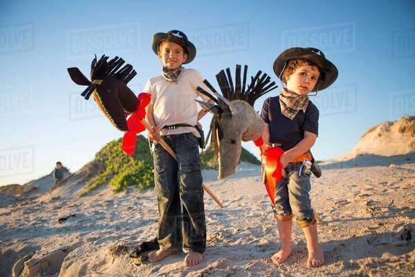 Two brothers dressed as cowboy's with hobby horse's - Royalty-free ...