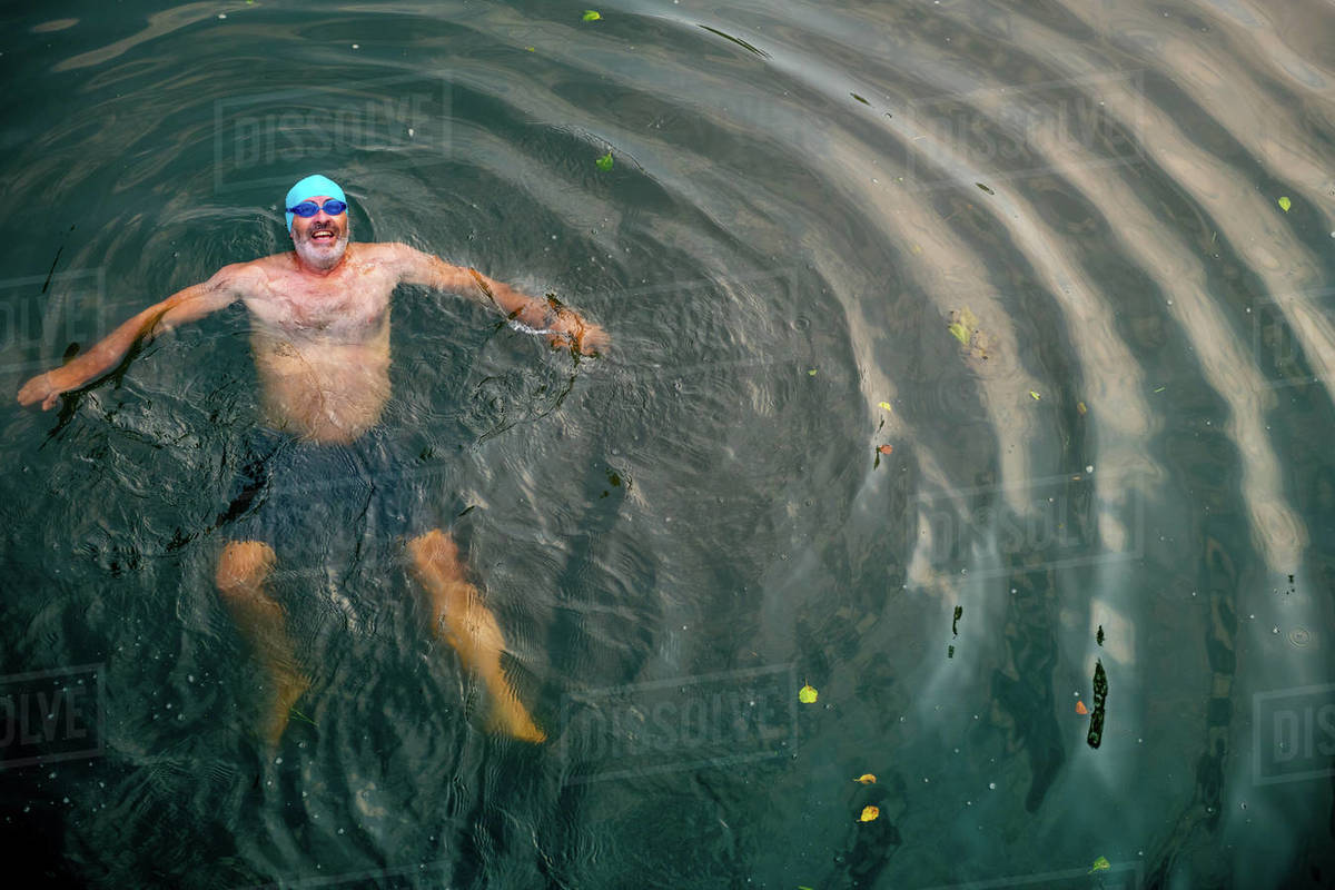 Man wild swimming in river, overhead view, River Wey, Surrey, UK ...