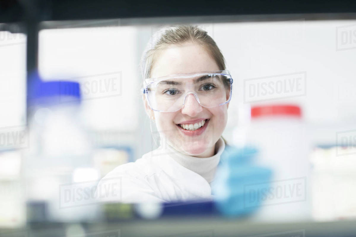 Young scientist smiling in the lab - Stock Photo - Dissolve
