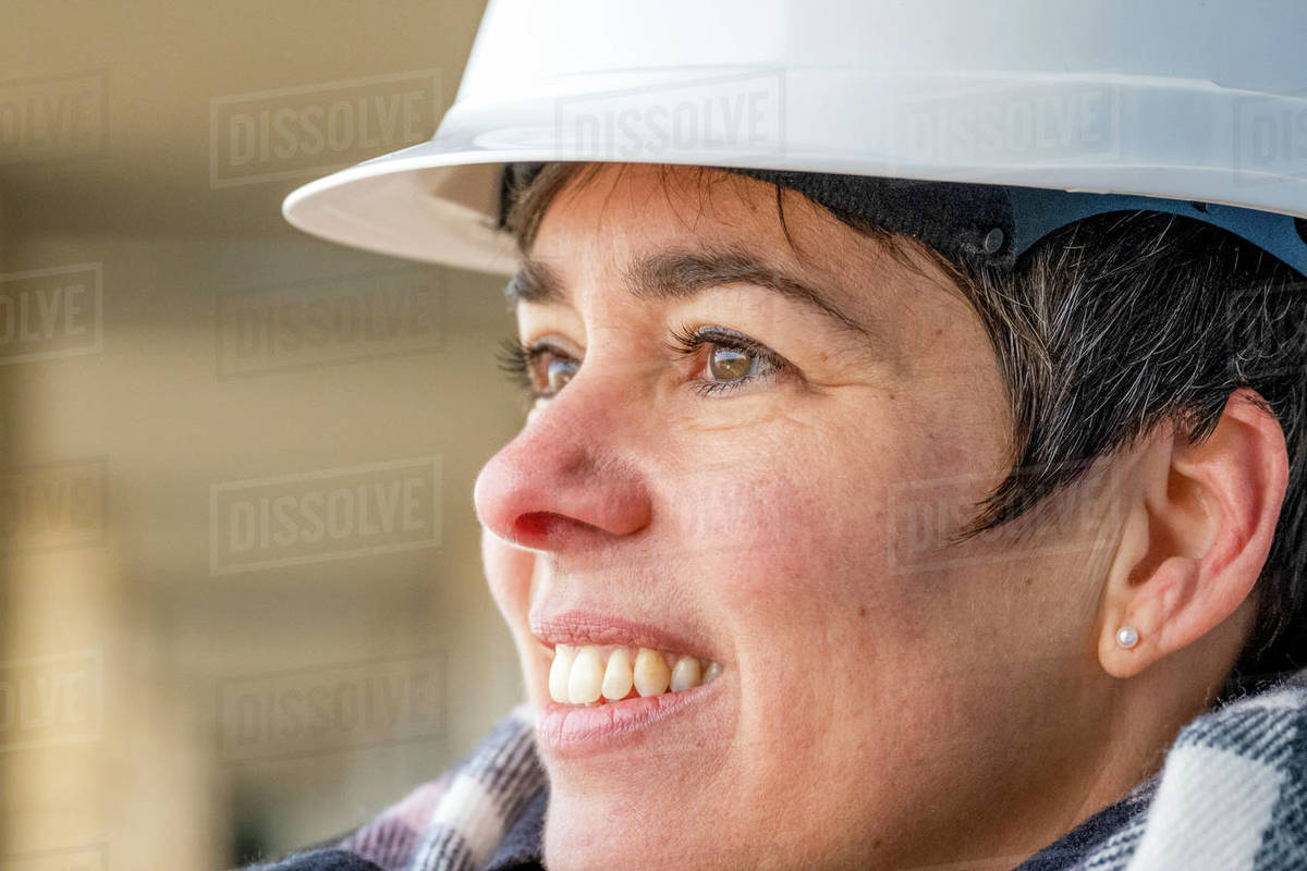 Female Construction manager walking around site - Stock Photo - Dissolve