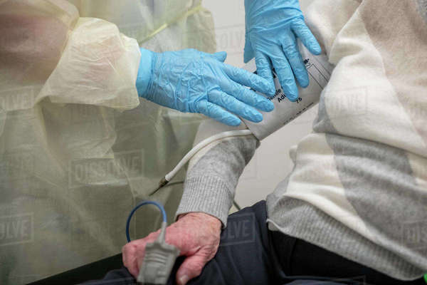 Elderly lady in a hospital bed under observation with healthy issues ...