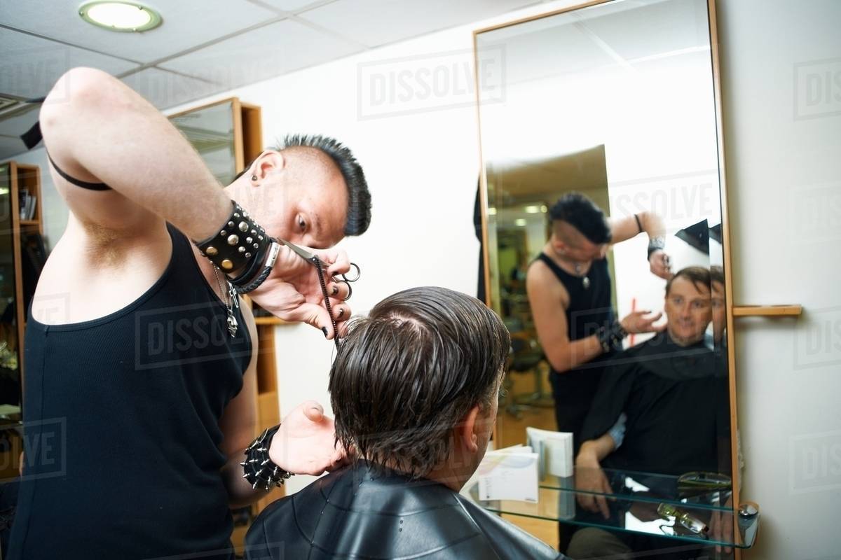 Male student barber cutting mans hair in college hairdressers - Royalty ...