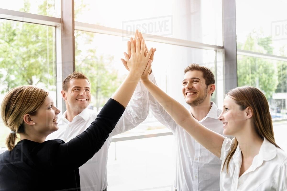 Businessmen and businesswomen cheering - Stock Photo - Dissolve