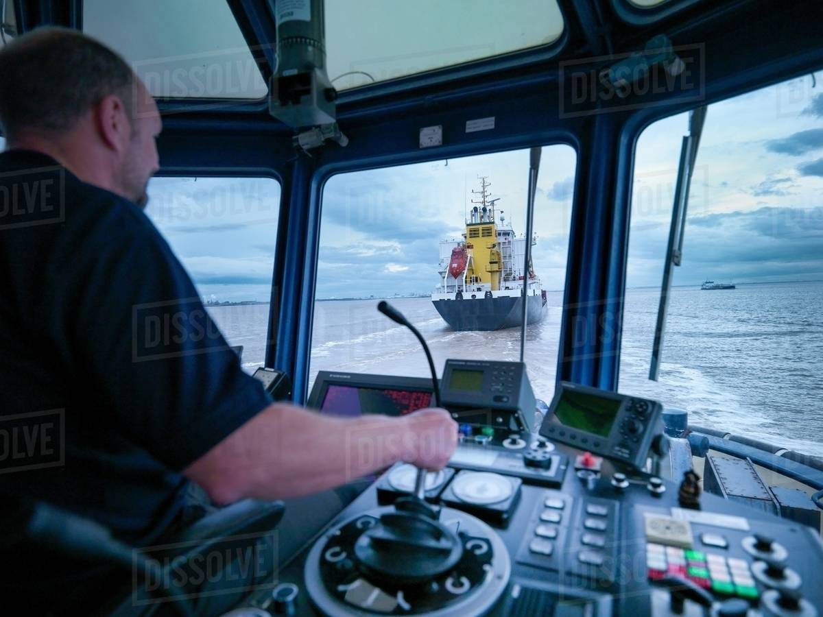 Captain steering tug out at sea view of ships bridge and tug seen ...