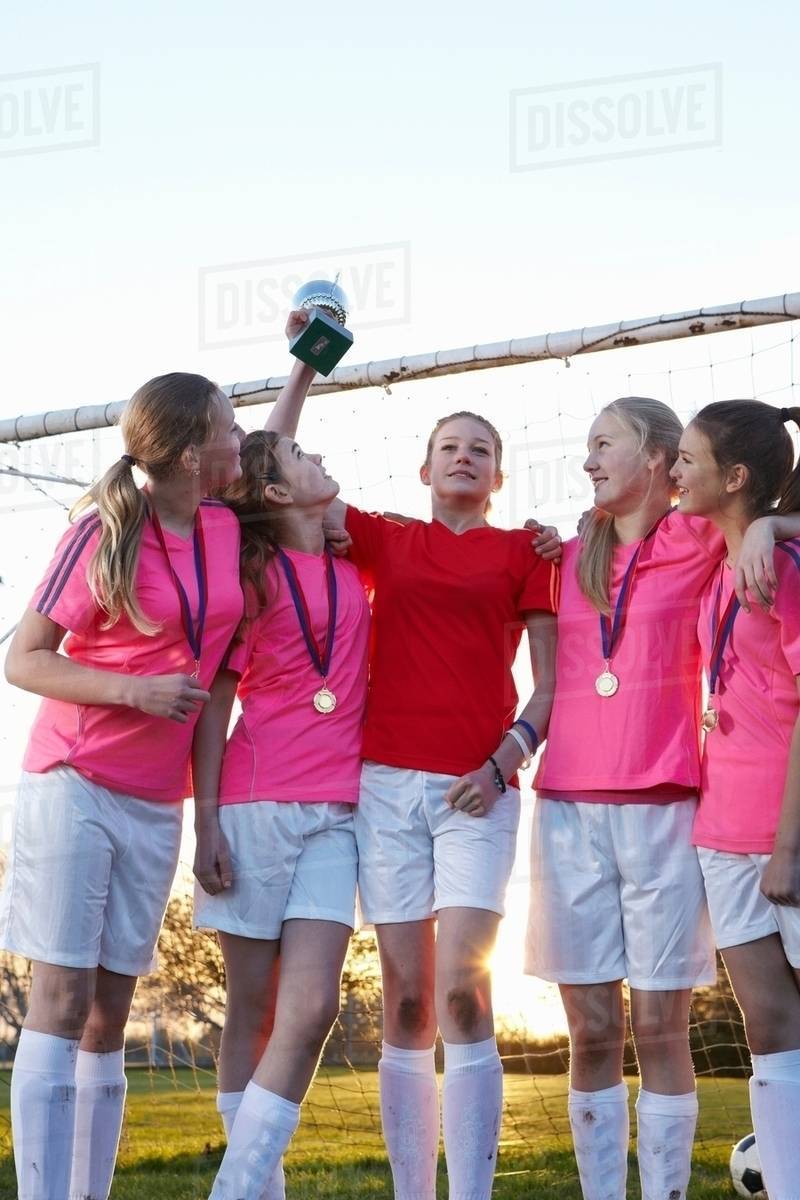 Football team cheering in field - Stock Photo - Dissolve