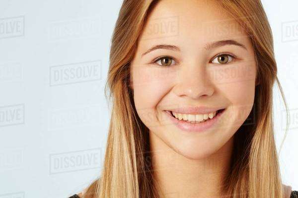 Close up of teenage girls smiling face - Stock Photo - Dissolve