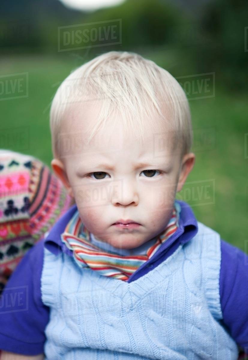 Close up of boys serious face - Stock Photo - Dissolve
