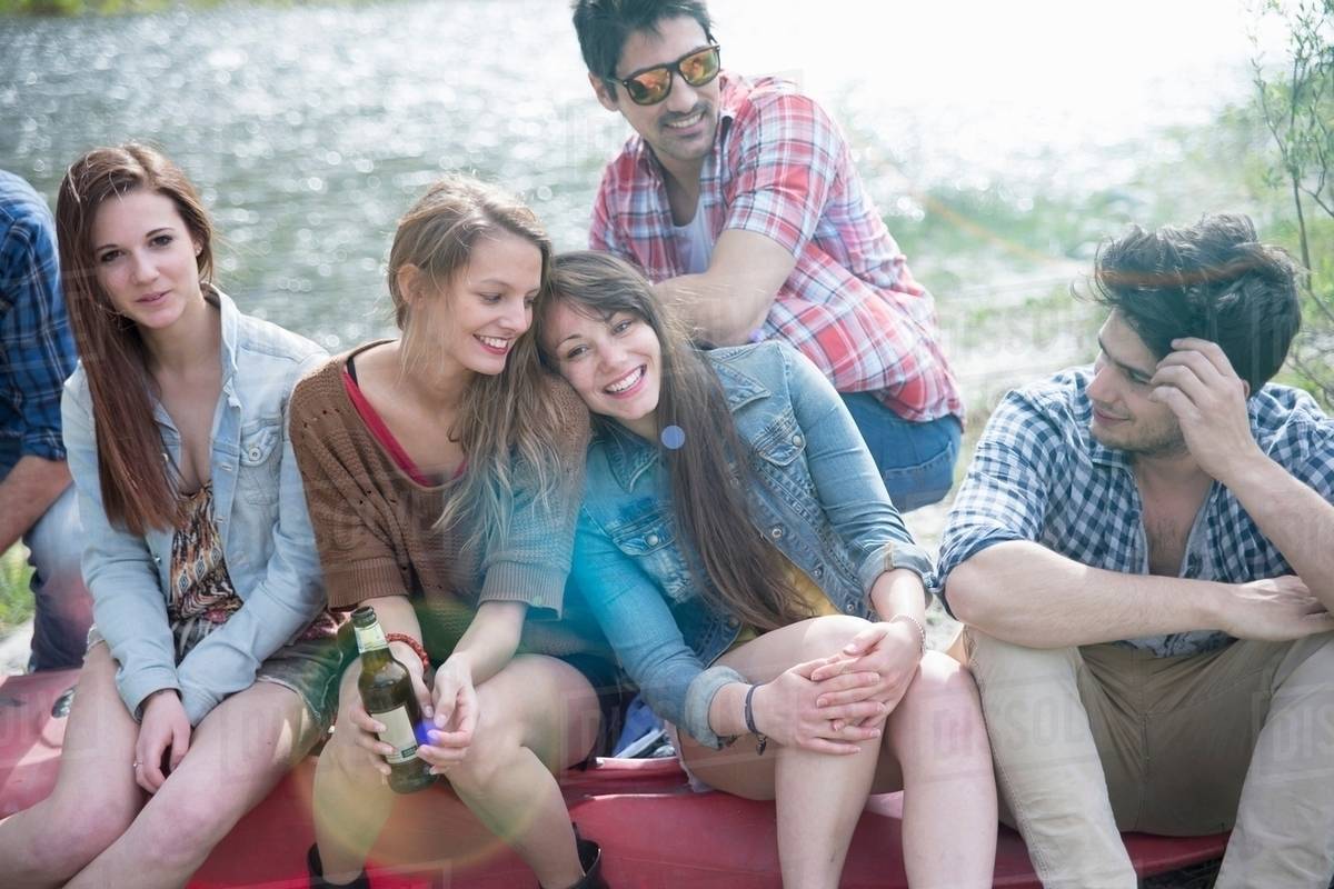 Group of six friends sitting on canoe - Royalty-free Stock Photo | Dissolve