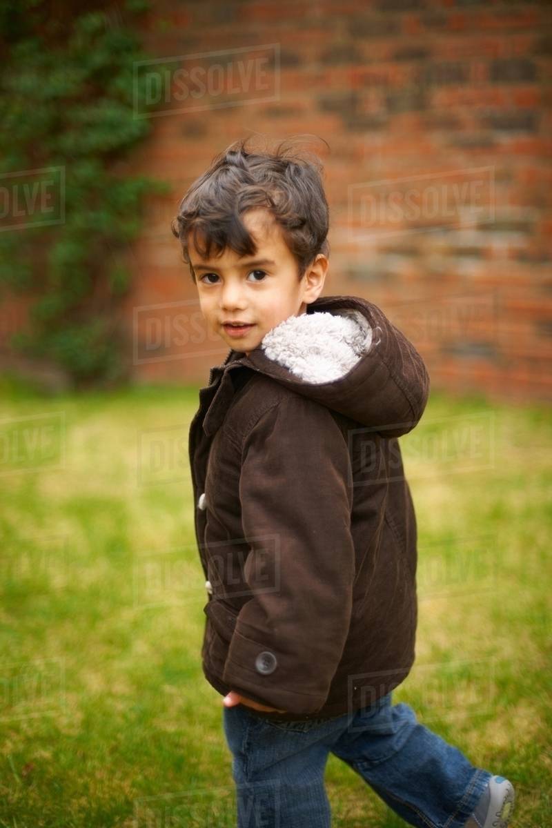 Boy walking in garden - Royalty-free Stock Photo | Dissolve