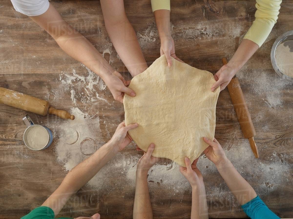 Overhead view of people making bread - Stock Photo - Dissolve