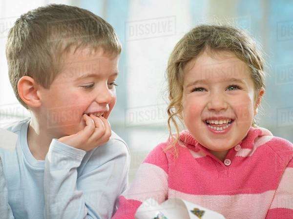 Children laughing together indoors - Stock Photo - Dissolve