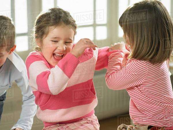 Children playing together indoors - Royalty-free Stock Photo | Dissolve