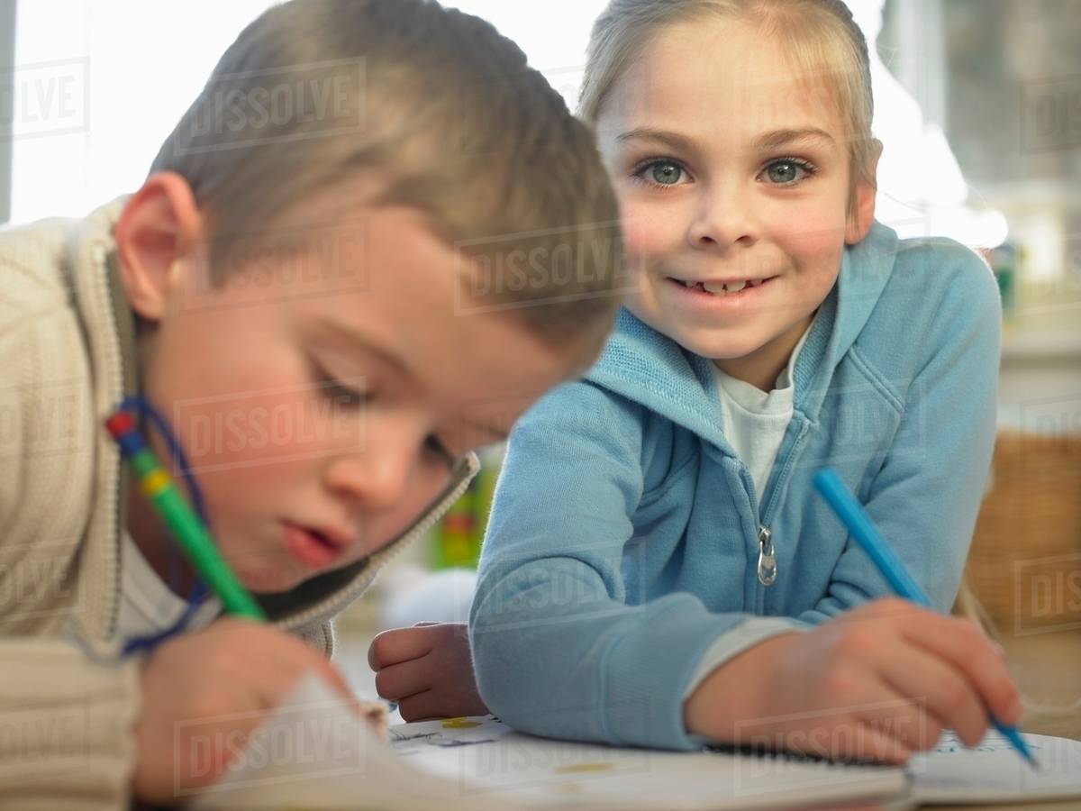 Children drawing together on floor - Royalty-free Stock Photo | Dissolve