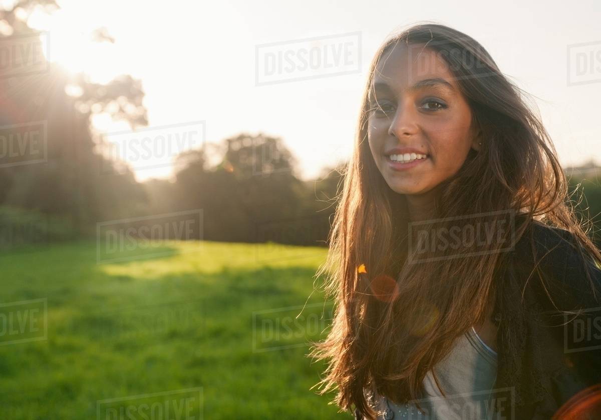 Teenage girl standing in field - Royalty-free Stock Photo | Dissolve