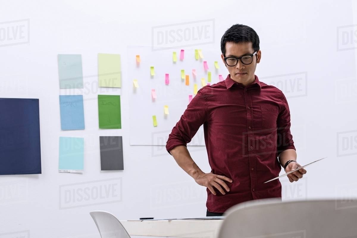 Young male preparing work in design studio - Stock Photo - Dissolve