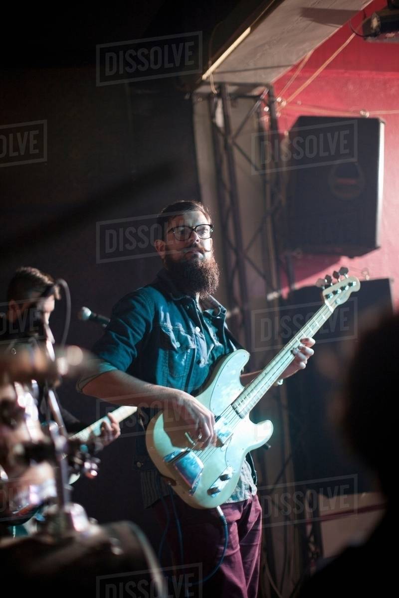 Men playing guitars on stage in club - Royalty-free Stock Photo | Dissolve