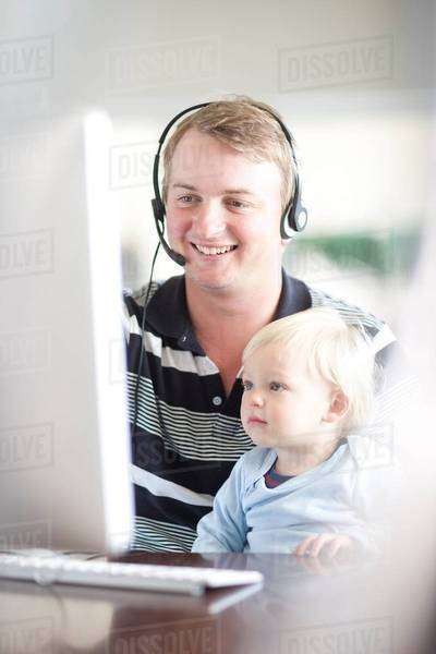 Father with baby boy using computer - Royalty-free Stock Photo | Dissolve