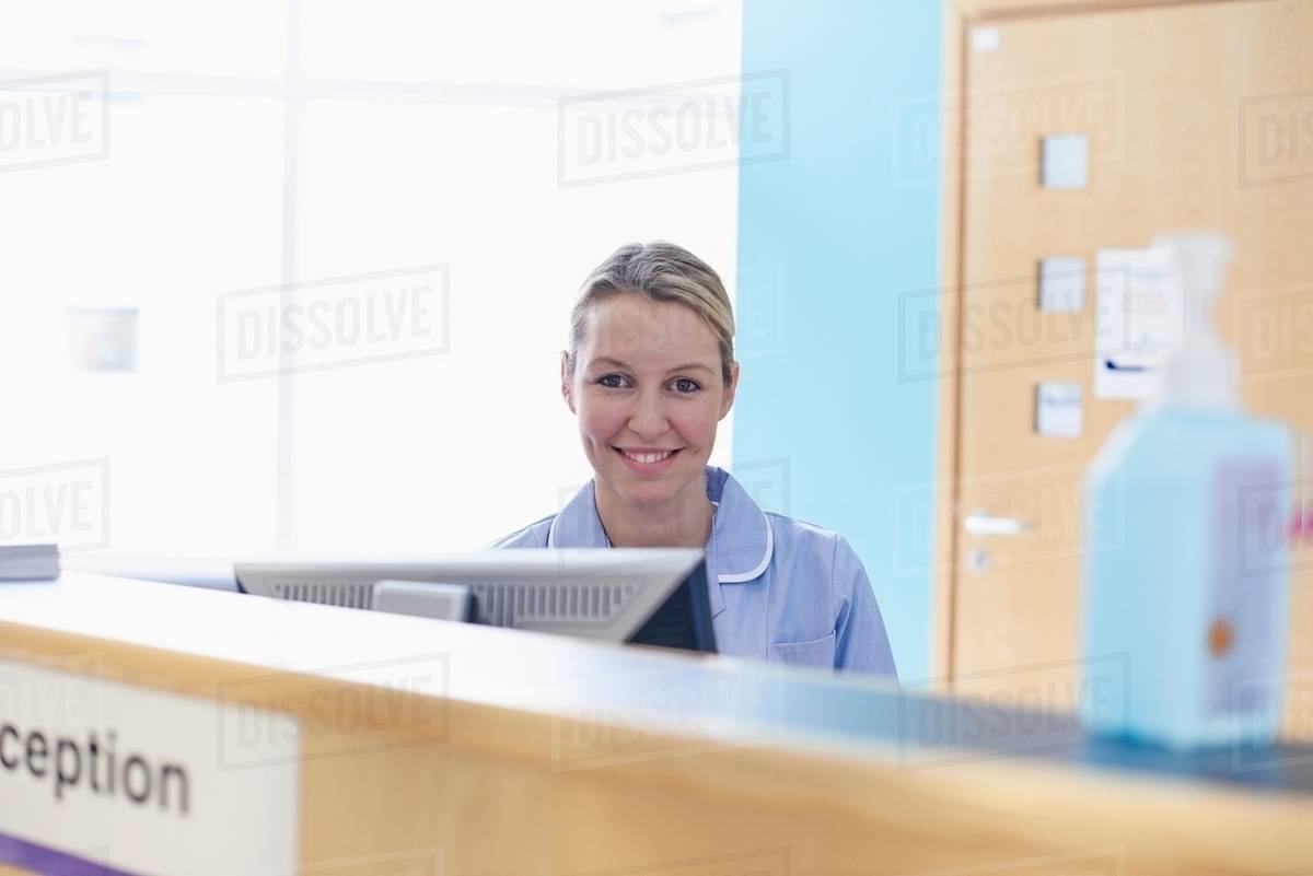 Nurse sitting at reception desk - Royalty-free Stock Photo | Dissolve