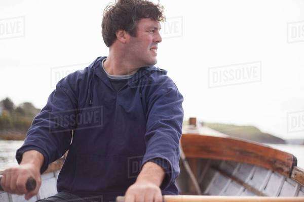 Portrait of man rowing in boat, Wales, UK - Royalty-free Stock Photo ...