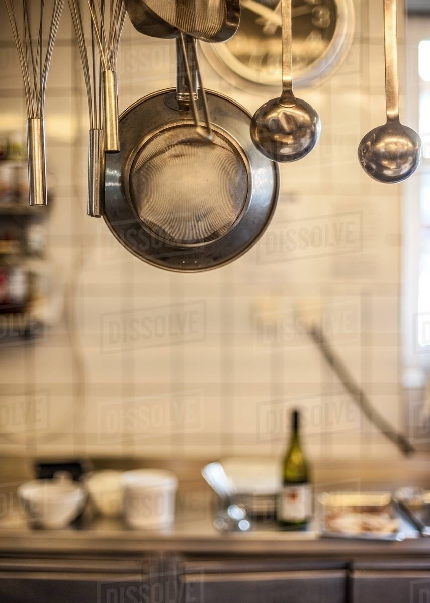 Metal utensils hanging in commercial kitchen - Royalty-free Stock Photo ...