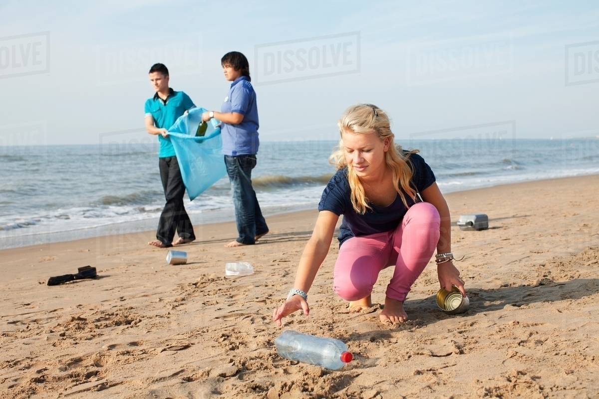 Teenagers collecting litter - Royalty-free Stock Photo | Dissolve