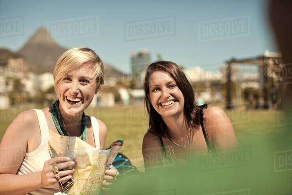 Two young women with map, Cape Town, South Africa - Stock Photo - Dissolve