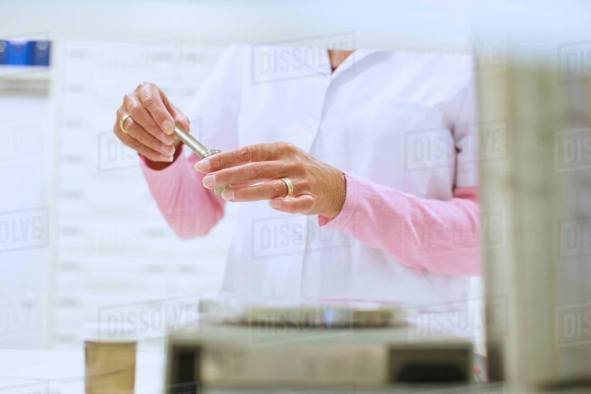 Female pharmacist measuring medicines for prescription - Royalty-free ...