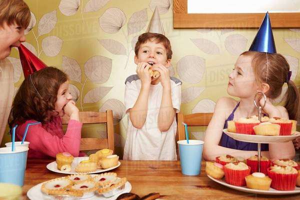 Children eating party food at birthday party - Royalty-free Stock Photo ...