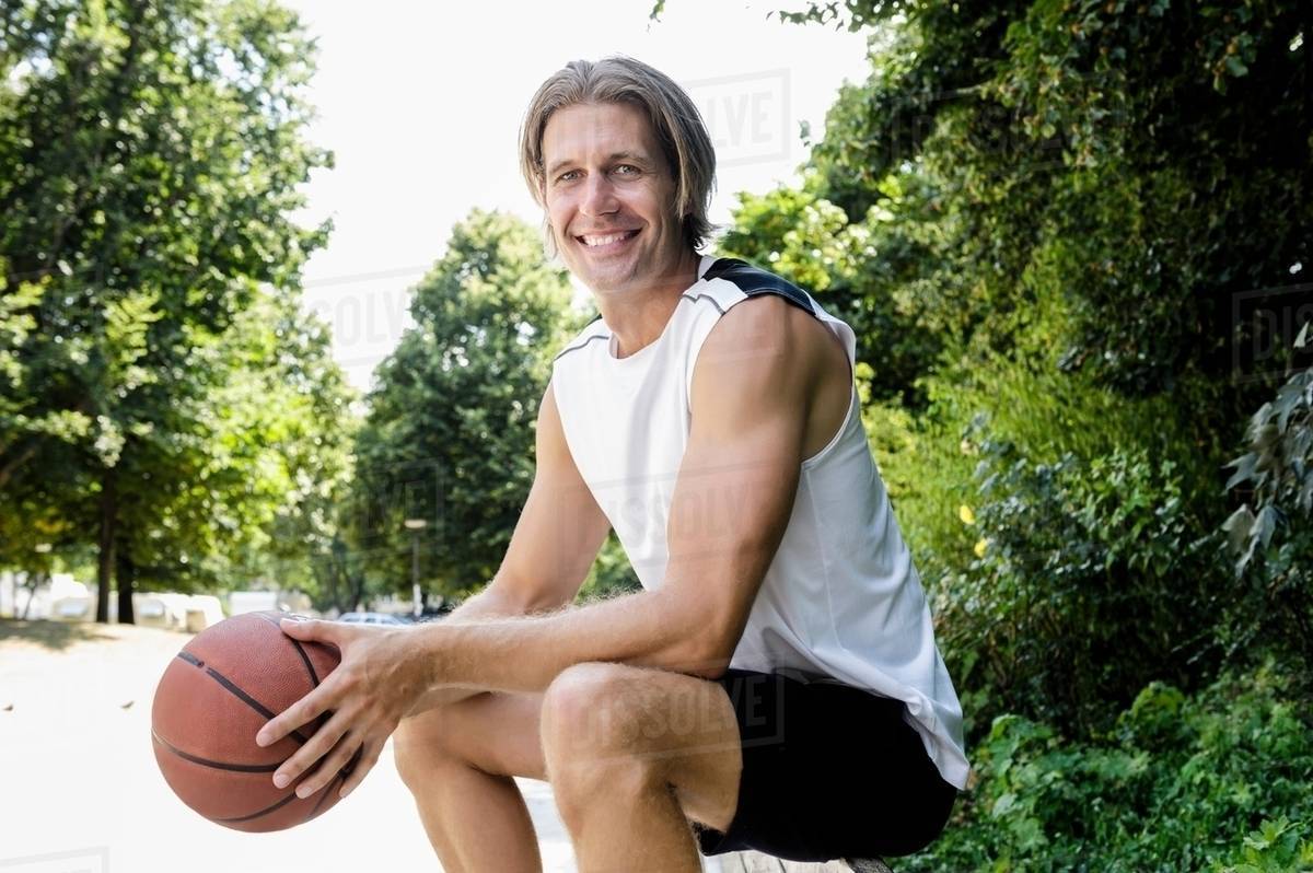 Portrait of male basketball player taking a break in park - Stock Photo ...