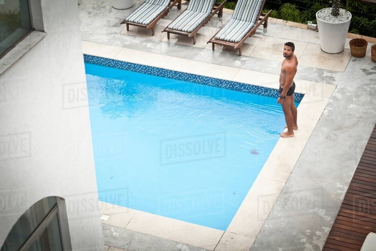 Man by poolside - Stock Photo - Dissolve