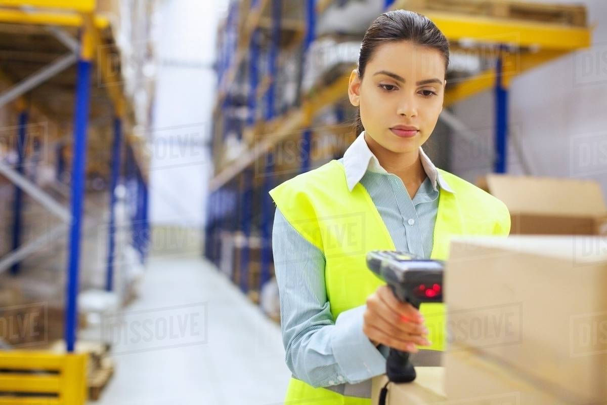 Young woman with barcode reader in distribution warehouse - Royalty ...