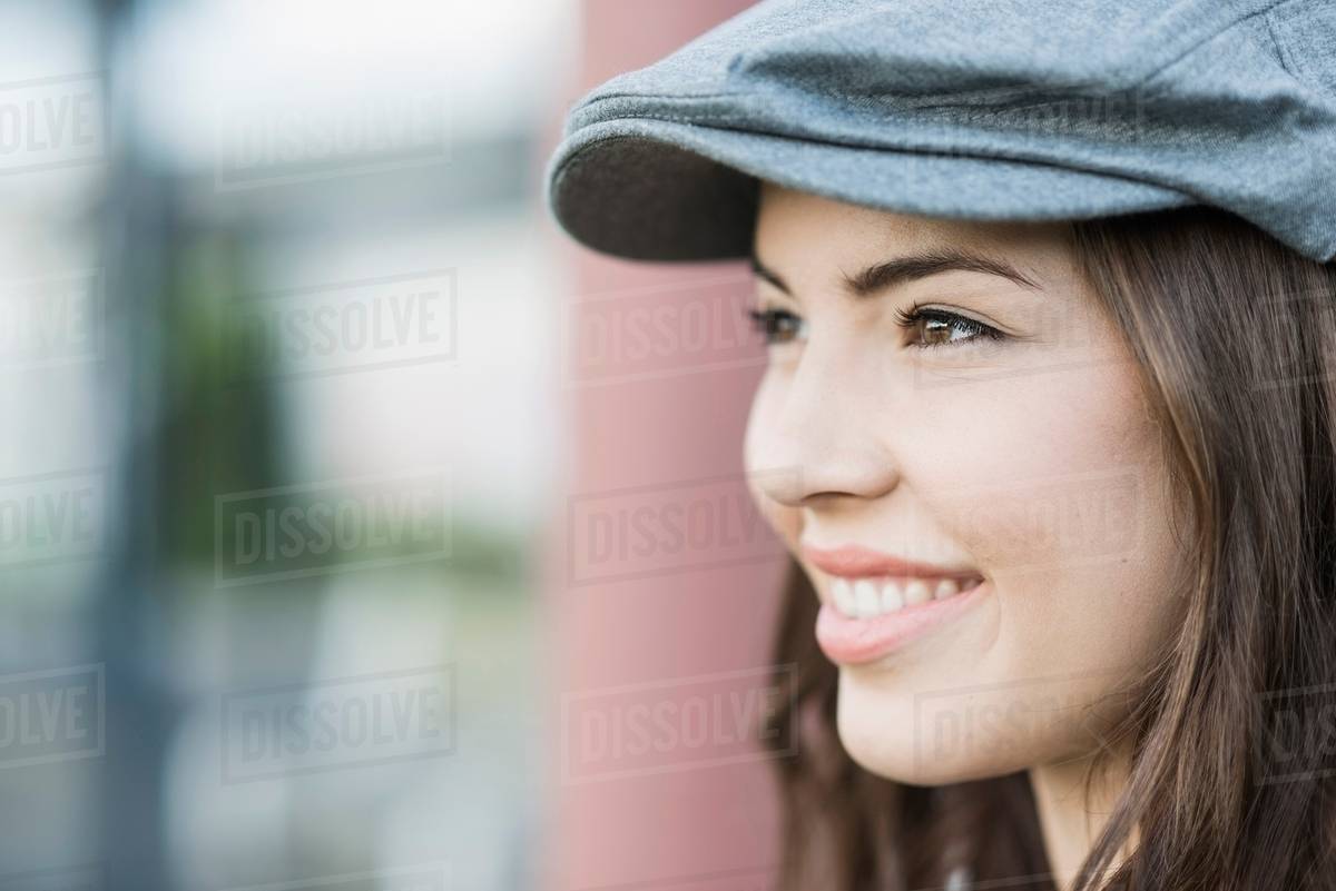 Young woman wearing flat cap, close up - Royalty-free Stock Photo ...
