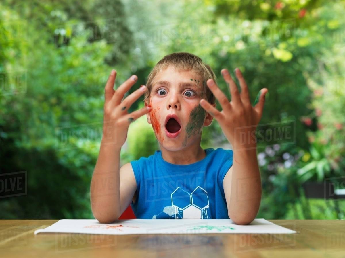 Boy paint on face, looking shocked - Royalty-free Stock Photo | Dissolve